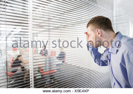 Mid-Adult Man Peering through House Window Stock Photo: 125938727 - Alamy