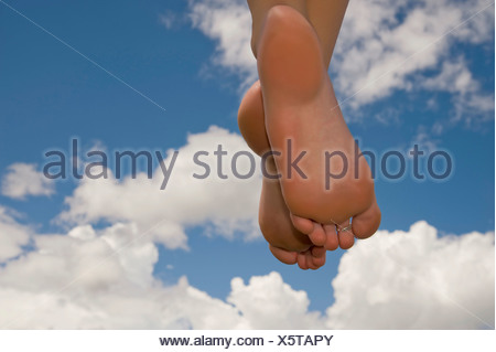 Angel Concept; Feet Floating In Sky Against Clouds Stock Photo - Alamy