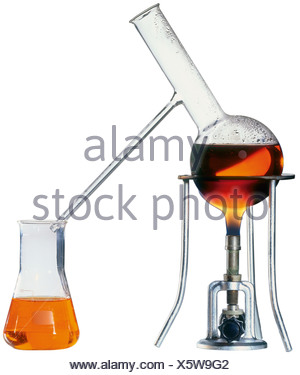 Bunsen burner heating flask with science equipment in laboratory Stock ...