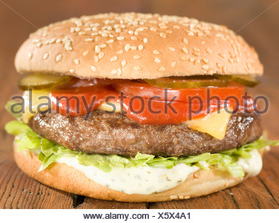 Classic burger with cheese and iceberg lettuce, close up Stock Photo ...