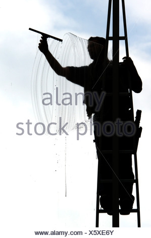 Silhouette of window cleaner cleaning window Stock Photo - Alamy