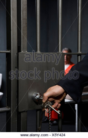 A prison guard locking a prison cell door Stock Photo - Alamy