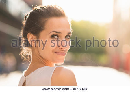Scared young woman looking over shoulder in the dark Stock Photo - Alamy