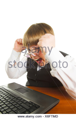 Angry young boy want to hit laptop computer Stock Photo - Alamy