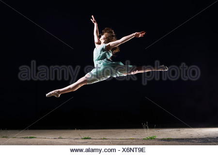 Female ballet dancer leaping mid air over lake, Bonneville Salt Stock ...