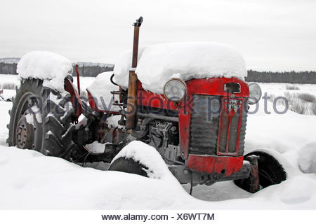 An old farm tractor covered in fresh winter snow Stock Photo - Alamy