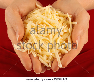 HANDFUL OF GRATED CHEDDAR CHEESE Stock Photo: 11310796 - Alamy
