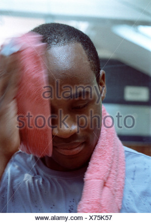 Exhausted man wiping sweat off his forehead Stock Photo - Alamy