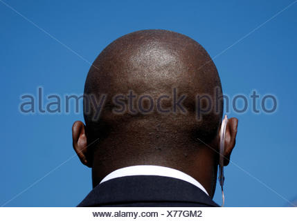 Bald head of black security guard against blue sky Stock Photo ...