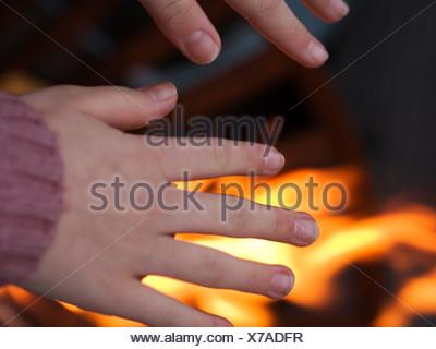 Person warming their hands over a fire Stock Photo: 16816036 - Alamy