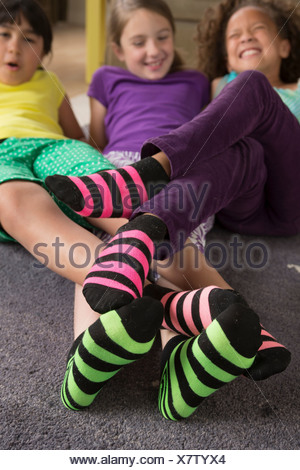 Three girls wearing brightly coloured socks Stock Photo: 61887931 - Alamy