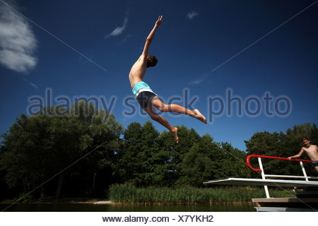 young boy jumping off a diving board Stock Photo: 27549875 - Alamy