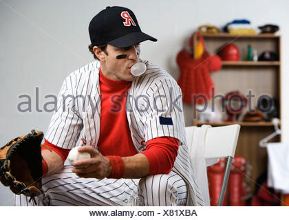 Baseball player blowing bubble gum locker room Stock Photo: 21678410 ...