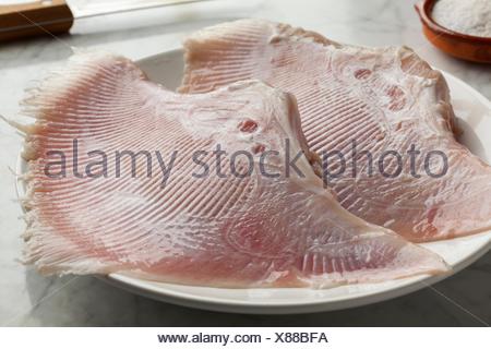 Cooking fresh raw stingray fish wings Stock Photo - Alamy
