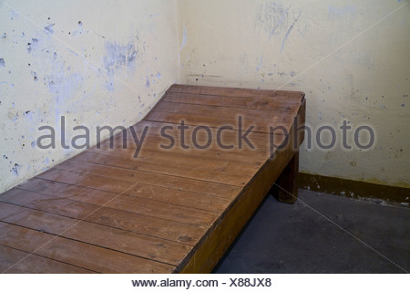 Prison cell, solitary confinement, cot with toilet bucket Stock Photo ...