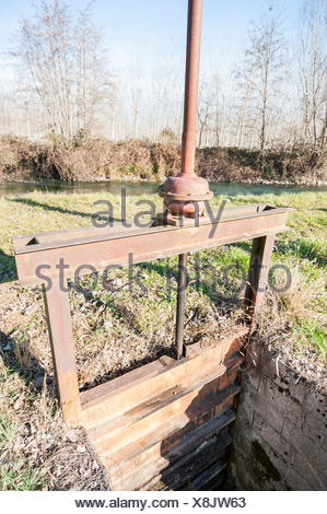 Irrigation Canal and old and manual Flood gate valve Stock Photo ...