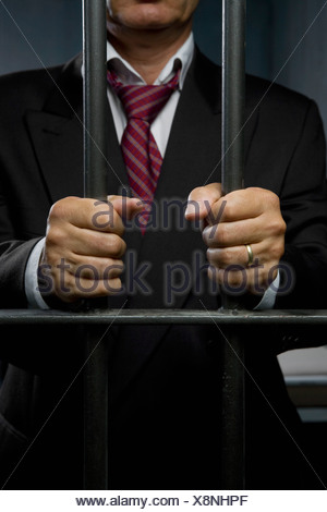 Man behind bars of jail cell Stock Photo: 618996 - Alamy