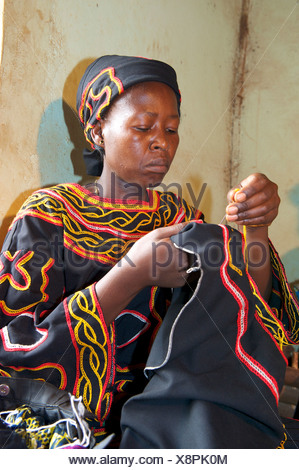 Woman wearing traditional dress doing embroidery work, Bamenda Stock ...