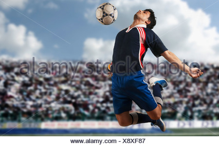 Soccer player trapping a soccer ball on chest Stock Photo - Alamy