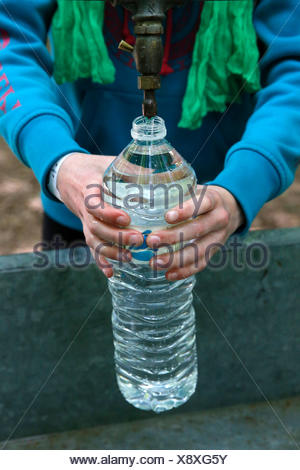 Girls filling up water bottle in kitchen Stock Photo - Alamy