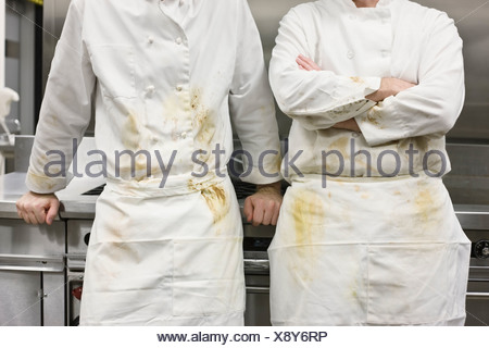 Dirty chefs leaning against stove Stock Photo: 20247584 - Alamy