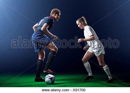 Male and female soccer players with ball Stock Photo: 61738691 - Alamy