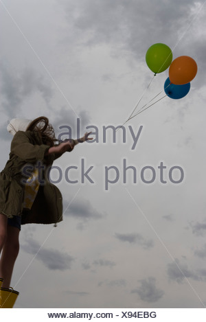 Child s hand letting go of balloon that is flying away because of the ...