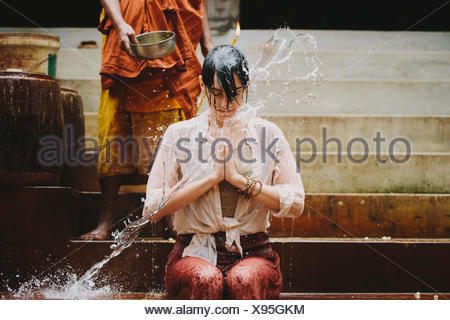 Cambodia, Buddhist monk water blessing young woman Stock Photo ...