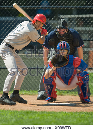 A baseball batter in front of a baseball catcher and umpire Stock Photo ...