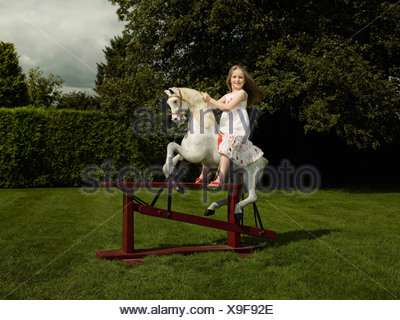 Girl smiling on rocking horse in playground Stock Photo: 72118720 - Alamy