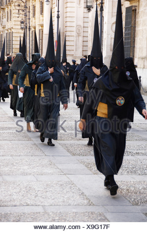 Penitent dressed in black penitential robe (nazareno) on their way to ...