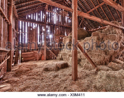 Interior of old barn with straw bales Stock Photo - Alamy