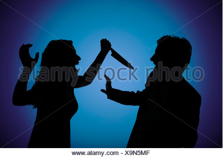 Woman attacking a man with a knife, silhouette, murder, crime Stock ...