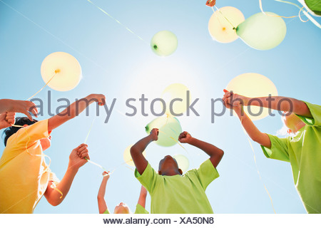 Child s hand letting go of balloon that is flying away because of the ...