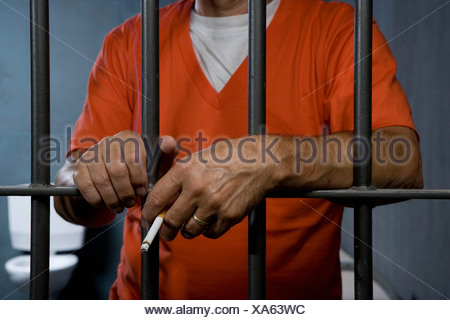 A prisoner smoking a cigarette in his prison cell Stock Photo: 20027689 ...