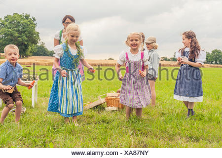 Germany, Saxony, children and their educator in traditonal clothes on ...