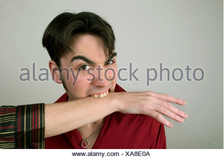 Young man biting a woman's arm. Released Stock Photo - Alamy