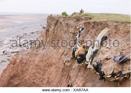 old landfill rubbish revealed in sea cliffs by coastal erosion on Stock ...