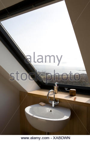 Basin below Velux window with view of the countryside in loft Stock ...