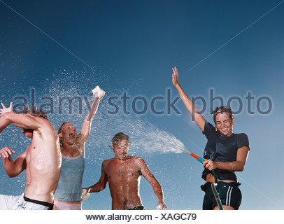 Teenage boy spraying water hose Stock Photo: 51456630 - Alamy