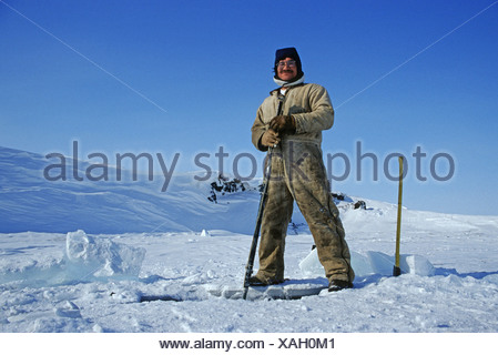 Inuit (Eskimo) men in fishing boats hunting whales with harpoons at sea ...