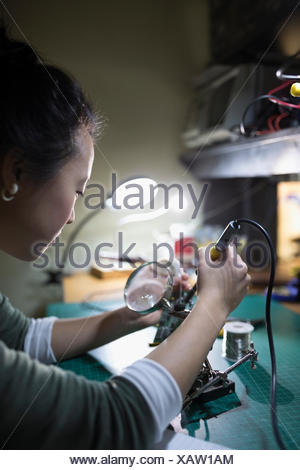 Woman with a soldering iron Stock Photo: 113364644 - Alamy