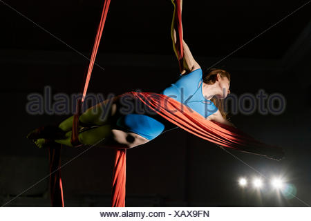 Young female aerial acrobat wrapped upside down in silk rope Stock ...