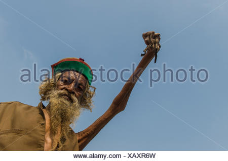 Crippled hand of a Shiva sadhu from Juna Akhara, holy man, practicing ...