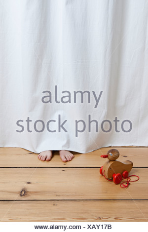 A Girls Feet Sticking Out From Beneath A Blanket Relaxing On A Couch ...