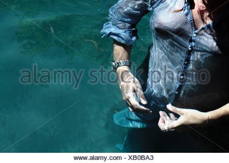 Fully clothed woman in a swimming pool Stock Photo - Alamy
