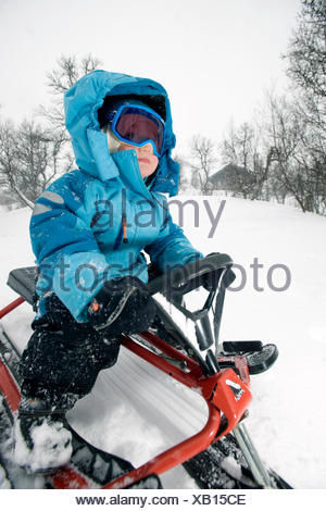 girl sitting on a snowmobile Stock Photo: 128956050 - Alamy