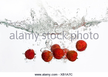 Lychee Splashing into Water Stock Photo - Alamy