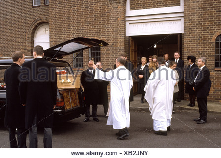 Catholic funeral where priest is blessing the coffin before it is Stock ...