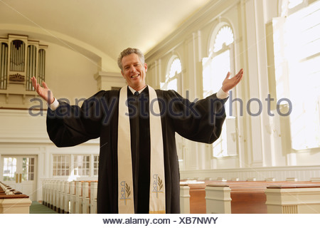 Priest with arms raised in church Stock Photo: 17106135 - Alamy